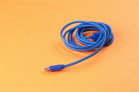 Premium Photo Coiled Blue Usb Wire On An Orange Background