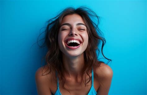 Premium Photo Woman In Blue Outfit Laughing Joyfully Showcasing Her