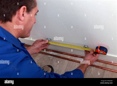Plumber Measuring Length Of Copper Pipe Stock Photo Alamy