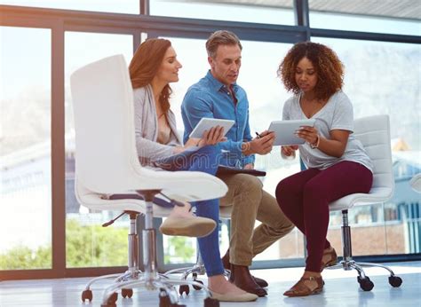 The Collaborative Team Is A High Functioning Team A Creative Team Using A Digital Tablet