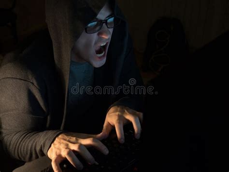 computer hacker man stealing information with laptop stock image