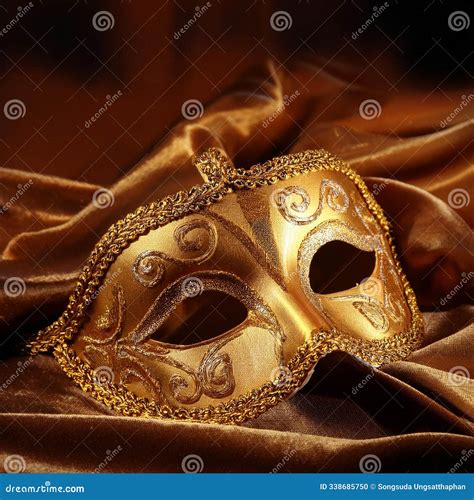 A Gold Mask Resting On A Velvet Surface Symbolizing Mystery And