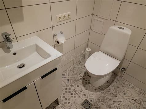 White Closed Toilet Bowl And Sink In A Bathroom Stock Image Image Of