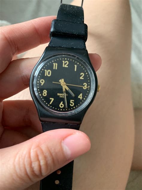 Swatch black gold watch on Carousell