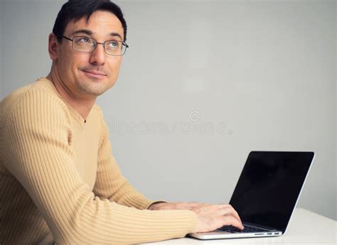 Man Sitting At Desk Working On Laptop Computer Stock Image Image Of Typing Looking 56554887