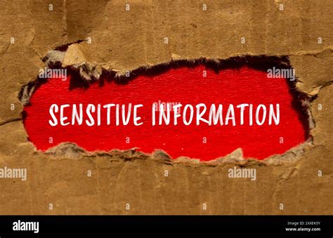 Sensitive Information Message Written On Torn Cardboard Paper With Red Background Conceptual