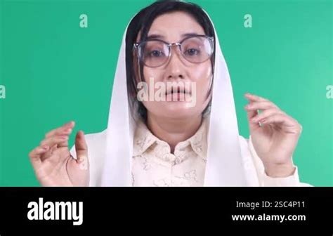 A Woman With A White Hijab And Glasses Rubs Her Eyes With Her Fingers