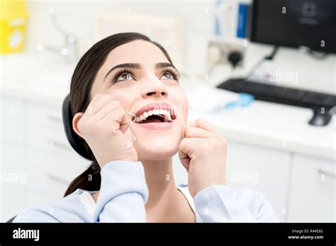 Female Cleaning Her Teeth With Dental Floss Stock Photo Alamy
