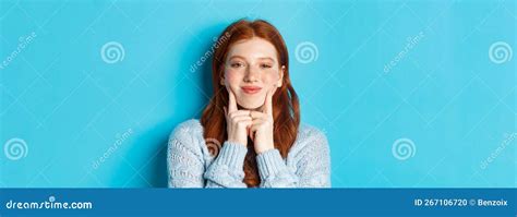 Close Up Of Cute And Silly Girl With Red Hair Poking Cheeks Showing