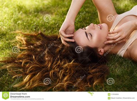 Beautiful Girl With Natural Pure Skin Lying And Relaxing Outdoors On