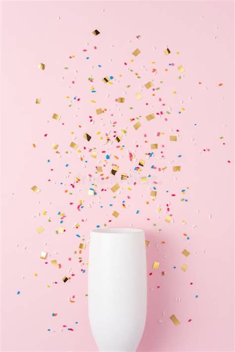 White Champagne Glass With Confetti On Pink Background Minimal Party