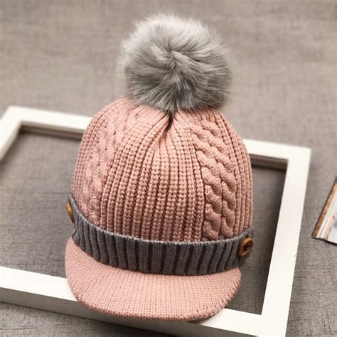 Badu Bg Зимна детска шапка с козирка и пухче в няколко цвята Badu Bg