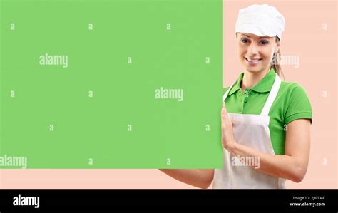 Female Grocery Store Assistant Holding A Green Sign Grocery Shopping