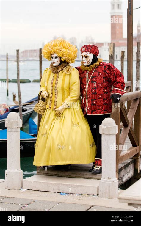 Couple Dressed In Traditional Venetian Costume Wearing A Bauta Mask For