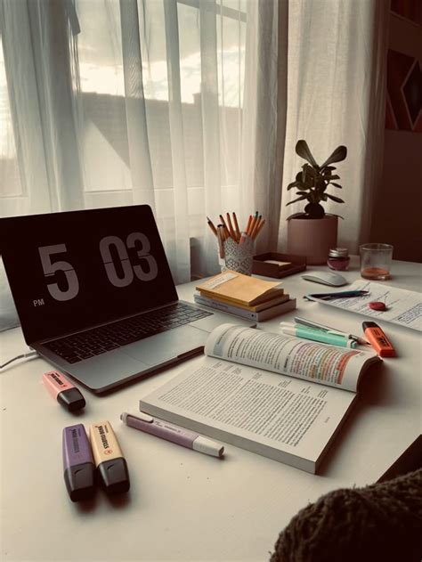 An Open Laptop Computer Sitting On Top Of A Desk Next To Books And Pencils