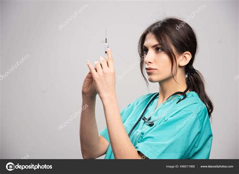 Female Doctor Preparing Injection Gray Background High Quality Photo