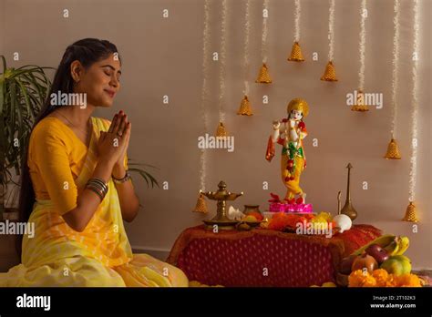 Woman Praying To Lord Krishna On The Occasion Of Janmashtami Stock