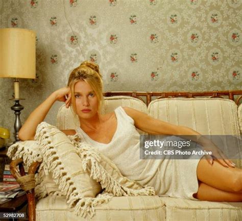 English Born Actress Nicollette Sheridan Lies On A Couch Against A
