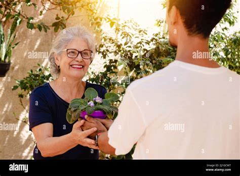 Caucasian Mother And Her Black Son In The House Garden Happy
