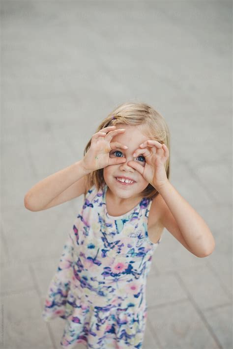 Goofy Young Girl Making Face Outside In Summer Dress By Stocksy