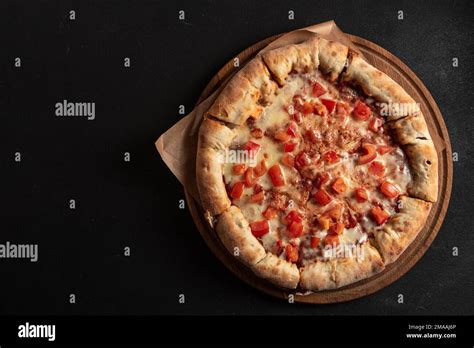 Neapolitan Pizza With Spices Tomatoes And Mozzarella Cheese On A Dark