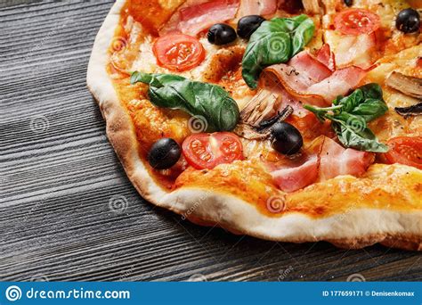 Top View Of Italian Pizza With Mushrooms Basil Tomato Olives And