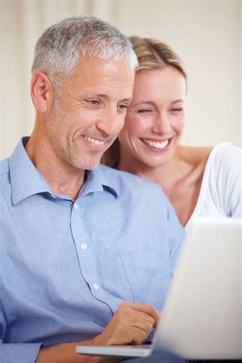 Checking What Movies Are Playinga Married Couple Smiling While