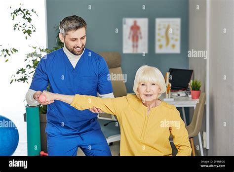 Senior Patient While Exercise Treatment With His Physiotherapist Rehab