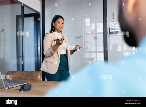 Presenting Business Strategy Woman Using Whiteboard Marker In Modern