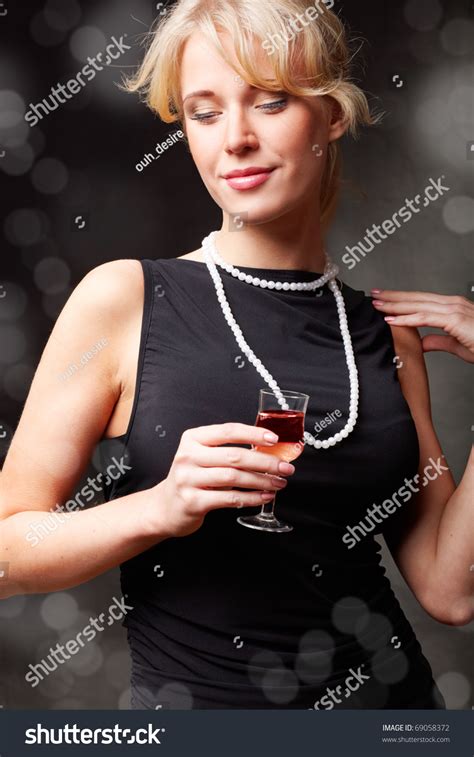 Portrait Of A Sexy Girl In Evening Dress Holding A Glass Of Wine On