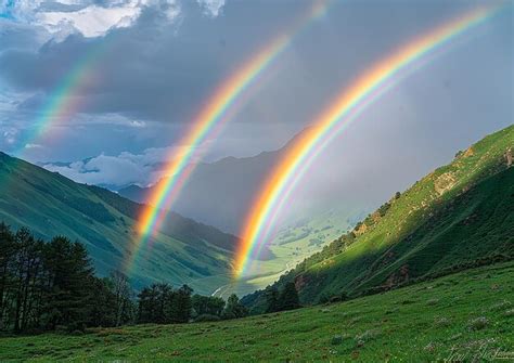 Double Rainbows On A Cloudy Day Premium Photo
