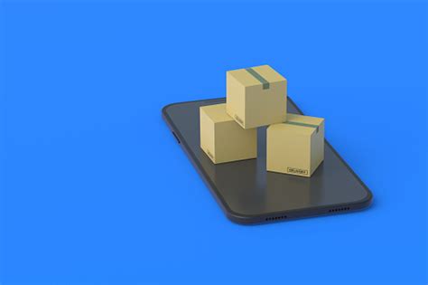 파란색 배경의 골판지 상자 근처의 스마트 폰 온라인 쇼핑 인터넷에서 구매 판매 원격 주문 상품의 배달 패키지 추적 전자 콤프스