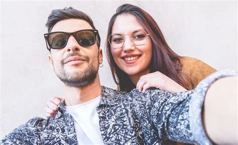 Premium Photo Low Angle Portrait Of Smiling Young Couple Standing