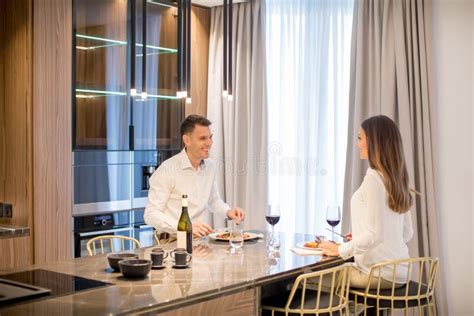Sweet Couple Having A Romantic Dinner At Luxury Kitchen Stock Image
