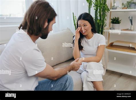 An Asian Woman Is Sad And Crying With Her Male Friend At Home Stress