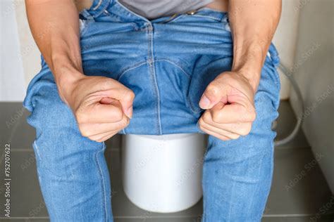 Man Sitting On The Toilet Bowl In The Bathroom He Has Stomach Ache