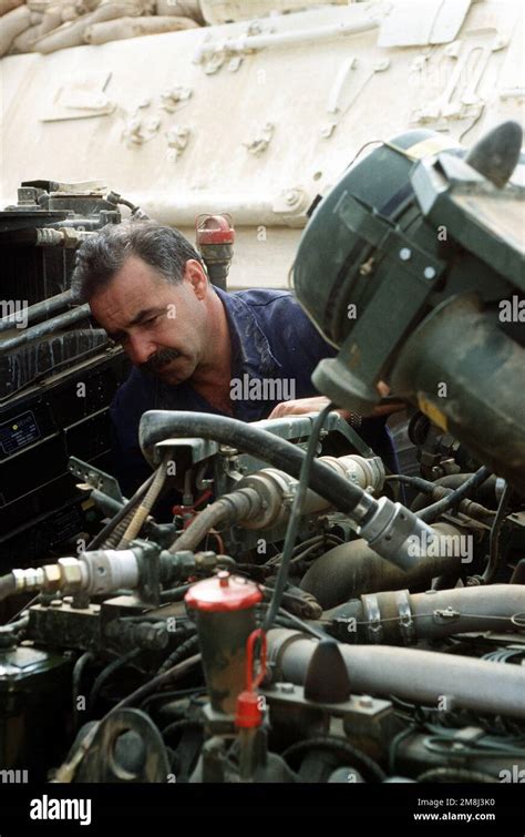 A German Soldier Repairs The Engine On An Armored Personnel Carrier The German Soldier Is Part