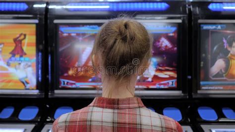Back View Woman Pushing Buttons And Playing Fighting Game Arcade