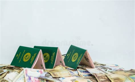 Multiple Ecowas Nigeria International Passport On A Heap Of Local Naira