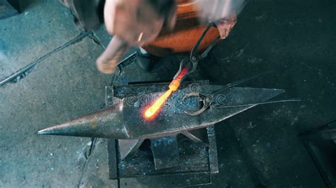 One Blacksmith Shapes Knife On Anvil Using Hammer Stock Footage