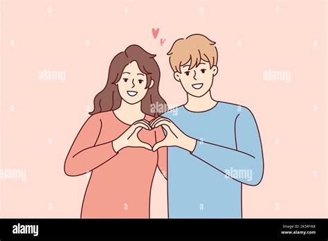 Smiling Couple Hug Show Heart Hand Gesture Happy Man And Woman