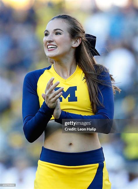 A Michigan Cheerleader Entertains The Crowd During The First Quarter