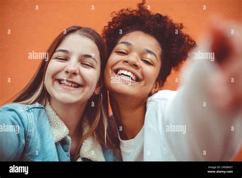 Self Portrait Of Two Happy Joyful Teen Girls Of Different Races Smiling