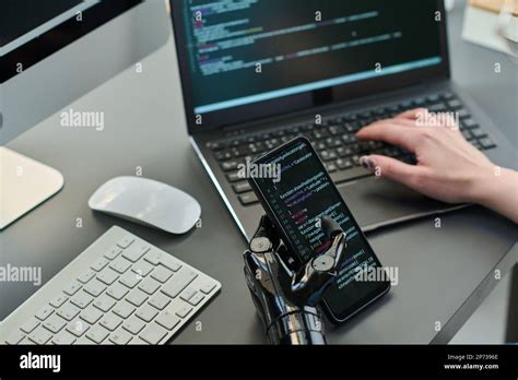 Close Up Of Developer Typing Security Codes On Smartphone And Laptop For New Computer Program