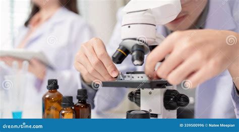 Scientist Conducting Microbial Analysis With Microscope For Research