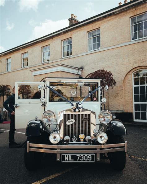 Vertical View Of A Classic Rolls Royce Wedding Car Parked Before A