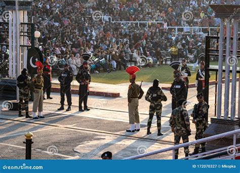 Indian Border Security Force Man Prepares To Lower Flags At Wagah
