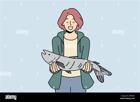 Smiling Woman Holding Fish In Hands Excited With Successful Fishing