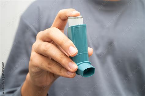Asthma And Chronic Obstructive Pulmonary Disease Copd Asian Young Man Using Metered Dose