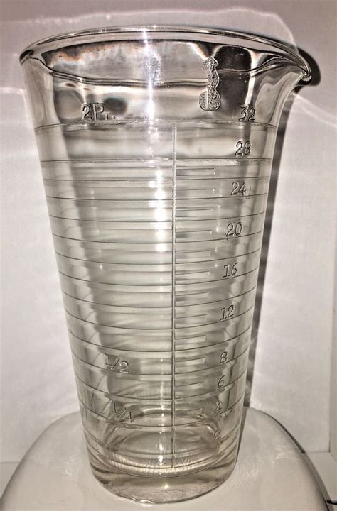A Large Glass Measuring Cup Sitting On Top Of A White Counter Next To A